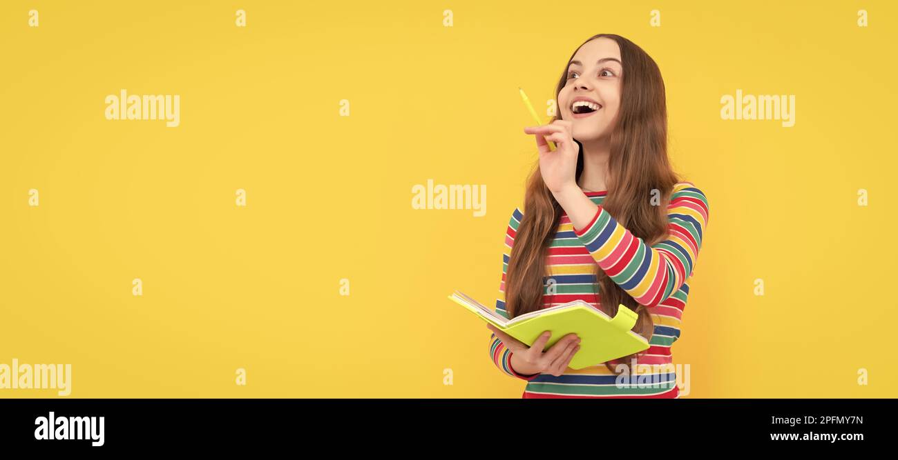 Happy kid genius got inspiration holding book and pointing pen up ...