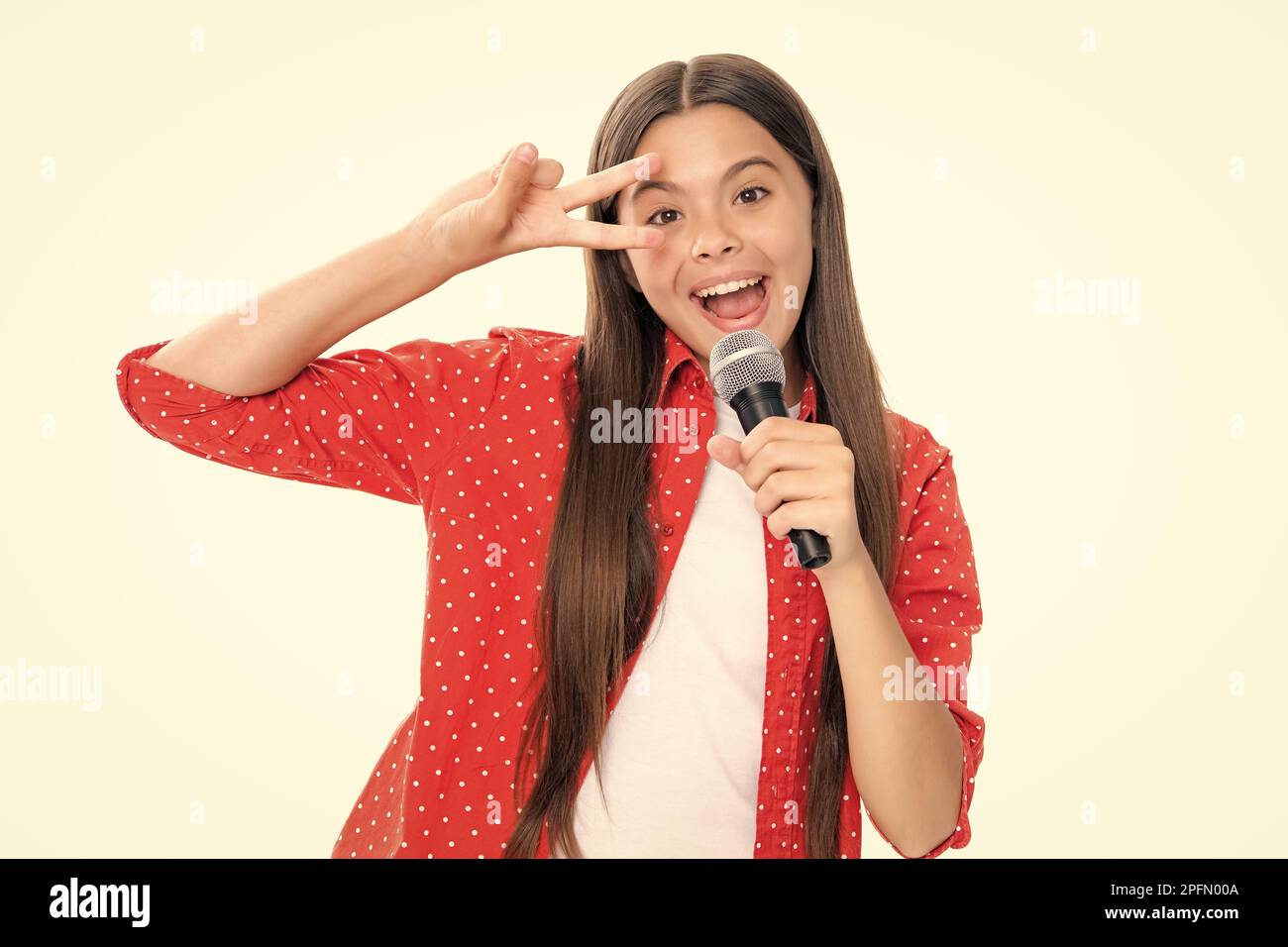 Teenage girl with microphone singing against white background with ...