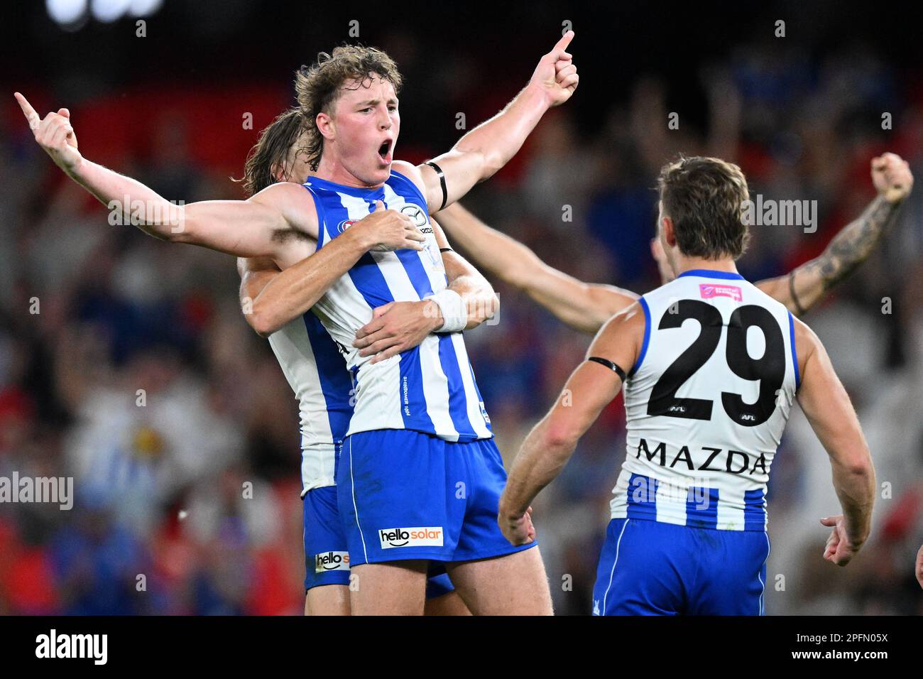 Nick Larkey of North Melbourne celebrates with team mates after kicking ...