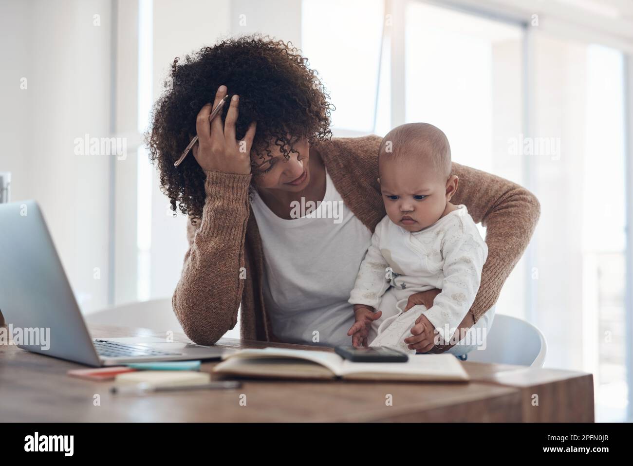 Splitting her attention gave her a splitting headache. a young woman ...