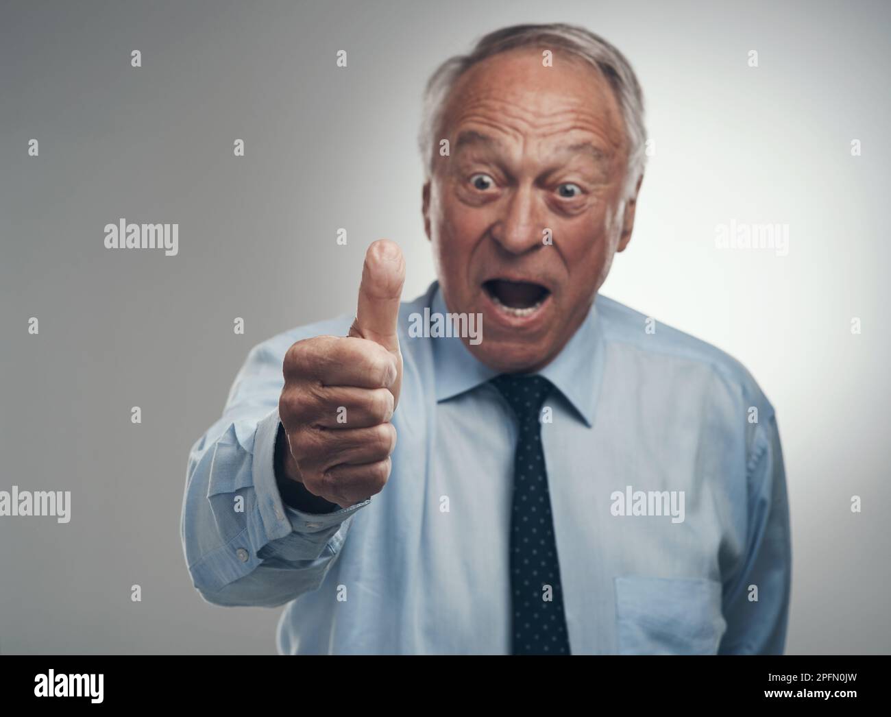 Wow Good for you. a senior businessman standing alone against a grey ...
