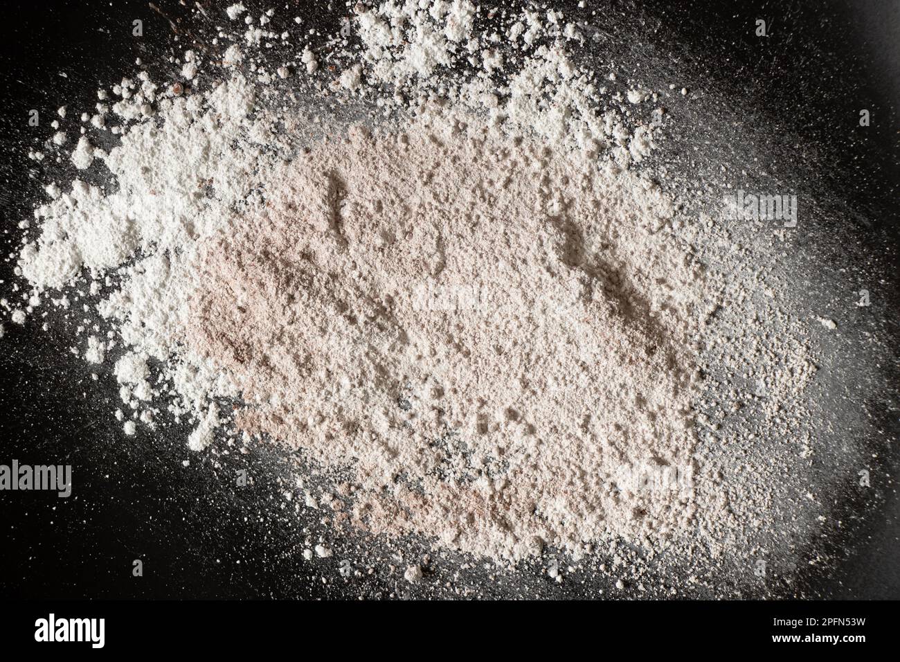 white powder on black background, flour sprinkled for background Stock ...