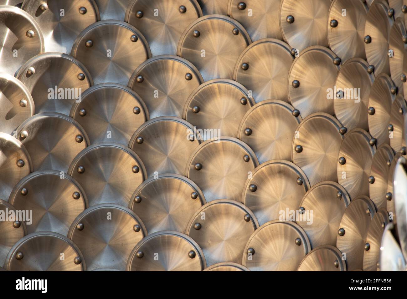 a lot of pot lids as a backdrop in the sunlight, a pot lid, kitchen ...
