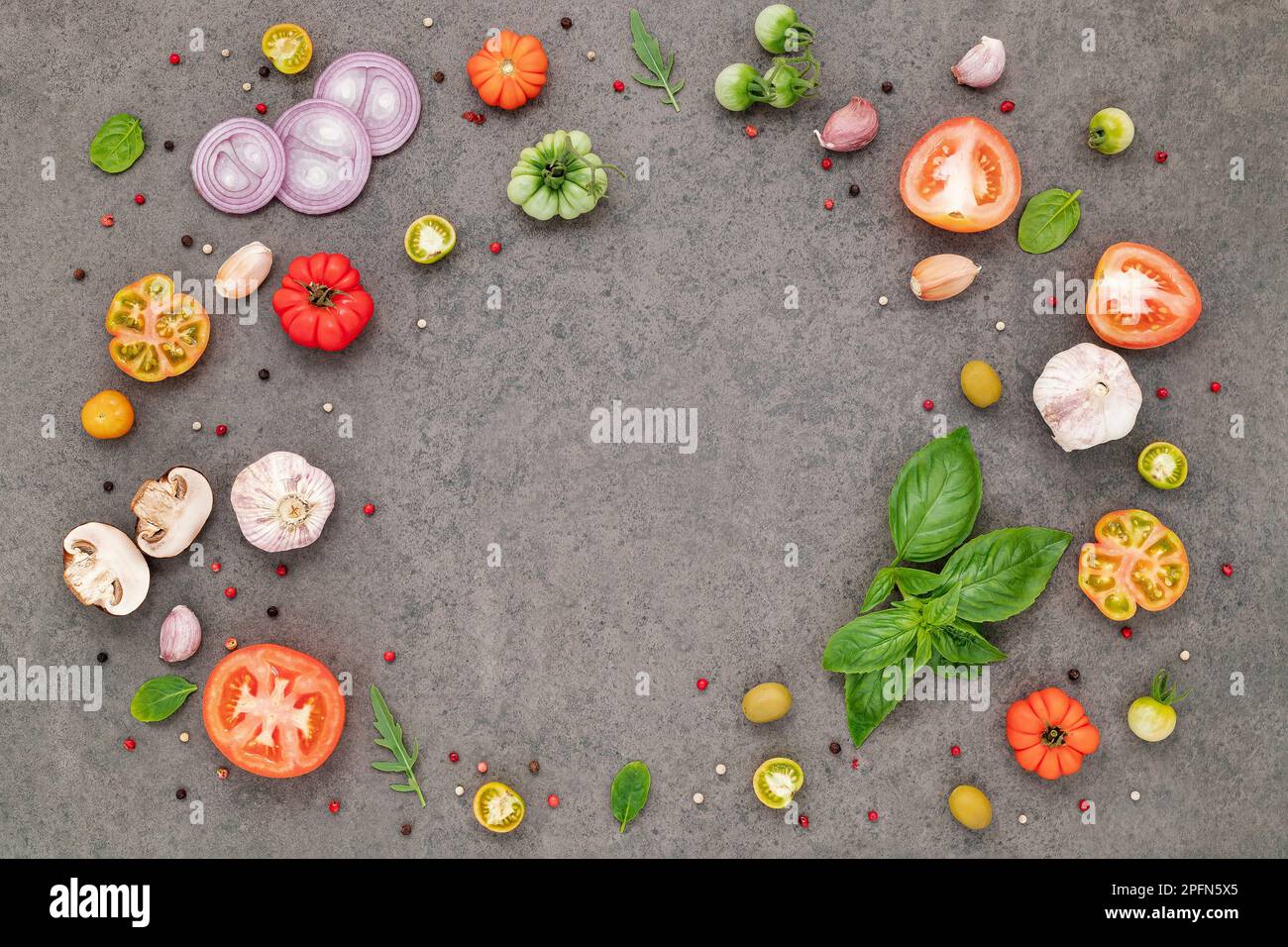 The ingredients for homemade pizza set up on dark stone background ...