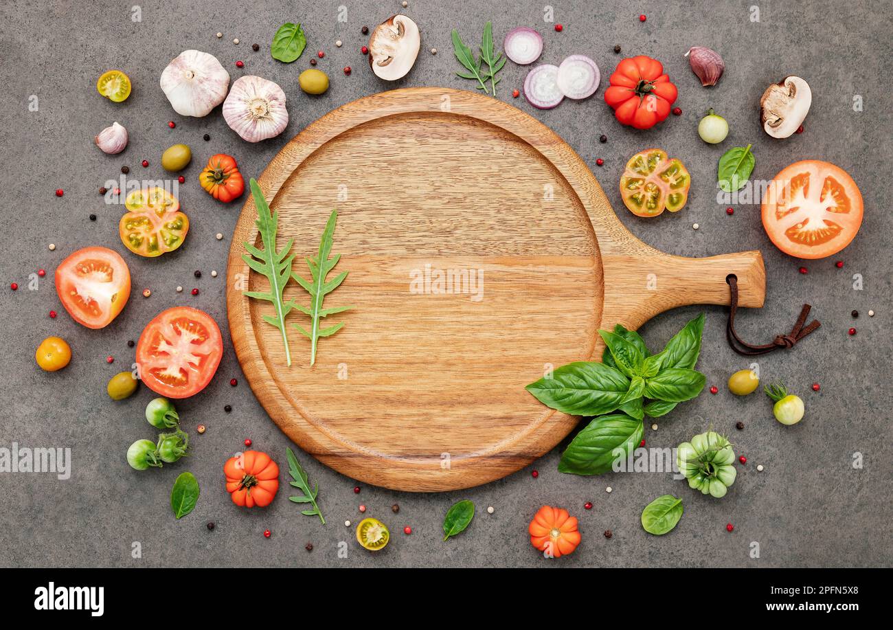 The ingredients for homemade pizza set up on dark stone background ...