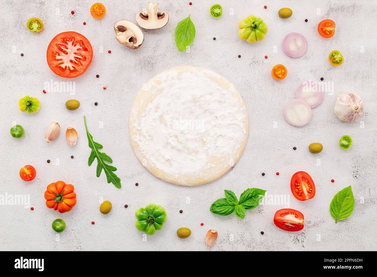 The ingredients for homemade pizza set up on white concrete background ...