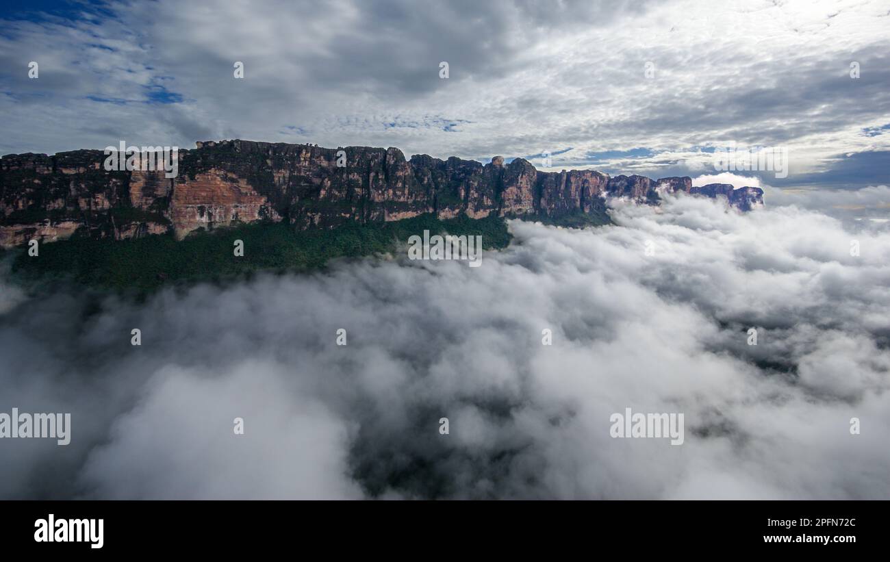 Towering sandstone rock cliffs of Auyan Tepui with clouds over the Gran ...