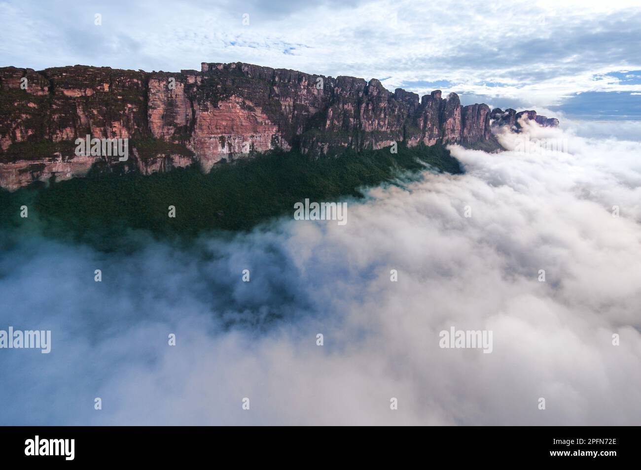 Towering sandstone rock cliffs of Auyan Tepui with clouds over the Gran ...