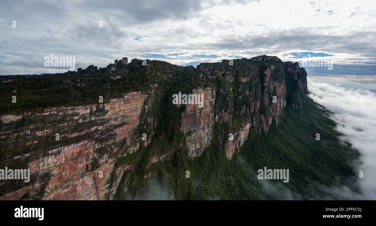 Towering sandstone rock cliffs of Auyan Tepui in the morning light with ...
