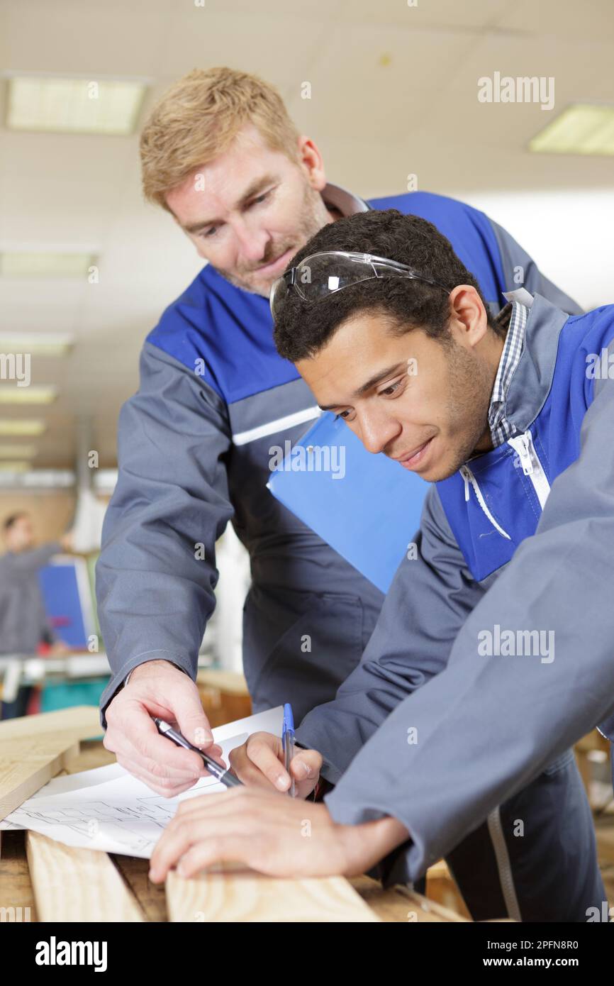 the carpenters studying a blueprint Stock Photo - Alamy