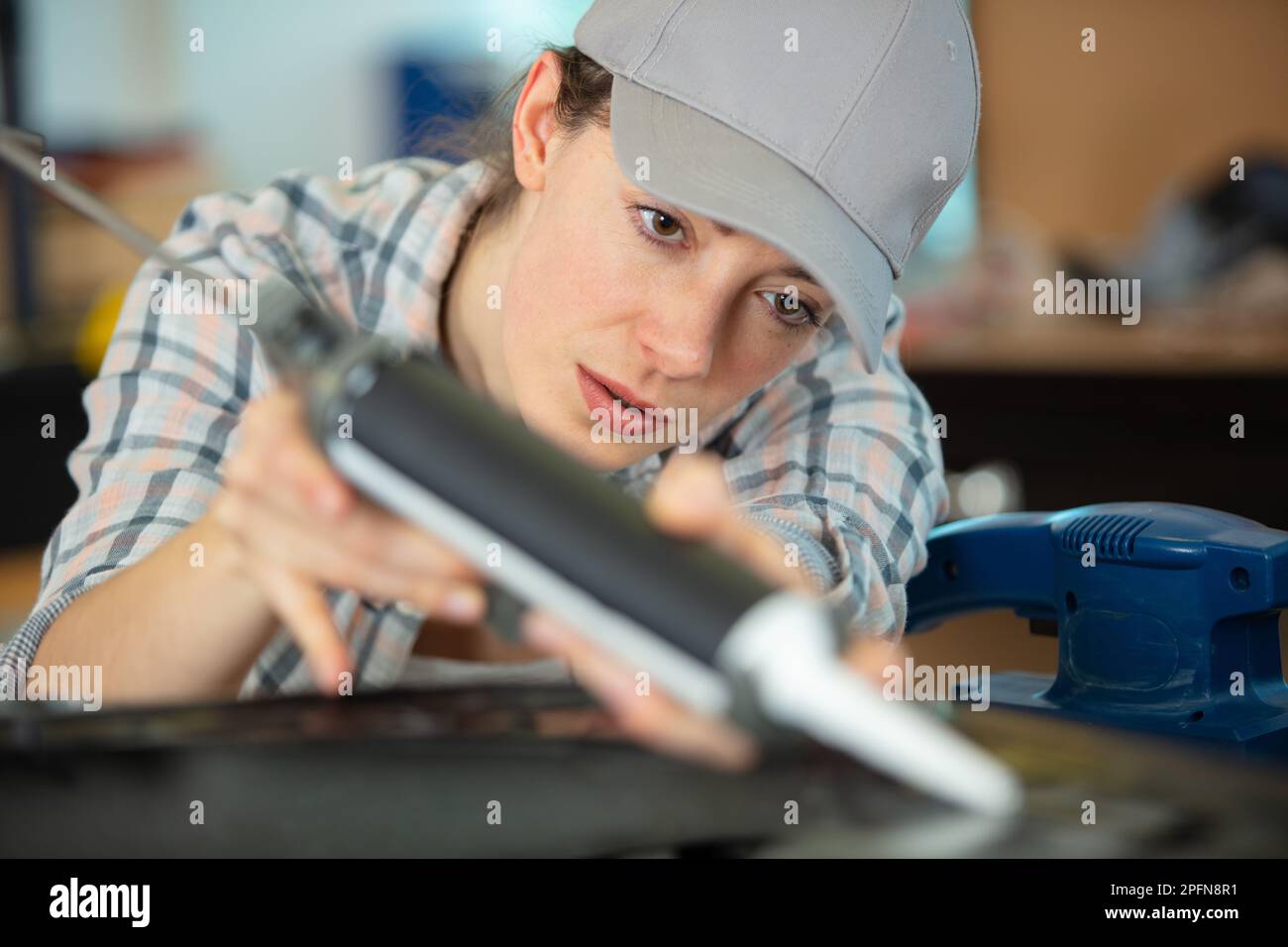 female worker using a silicone tube Stock Photo - Alamy