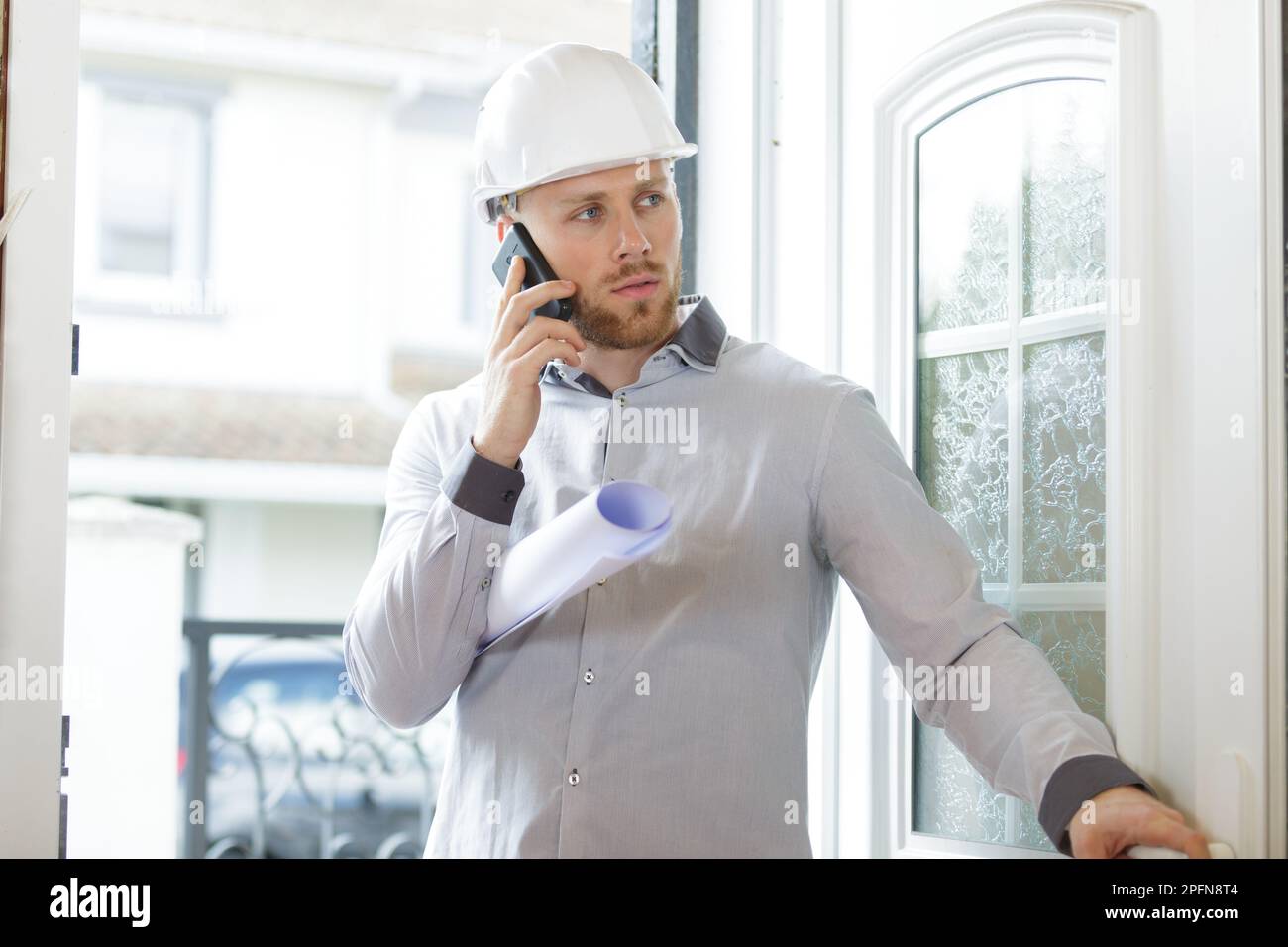 man of engineer using mobile contact Stock Photo - Alamy