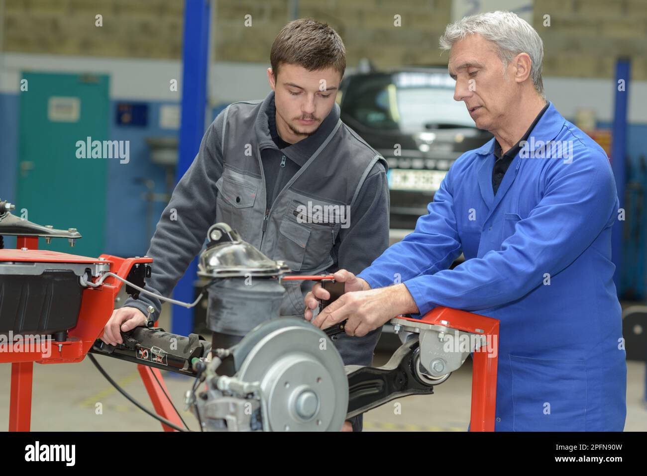 auto mechanic shows trainee maintenance of car engine Stock Photo - Alamy