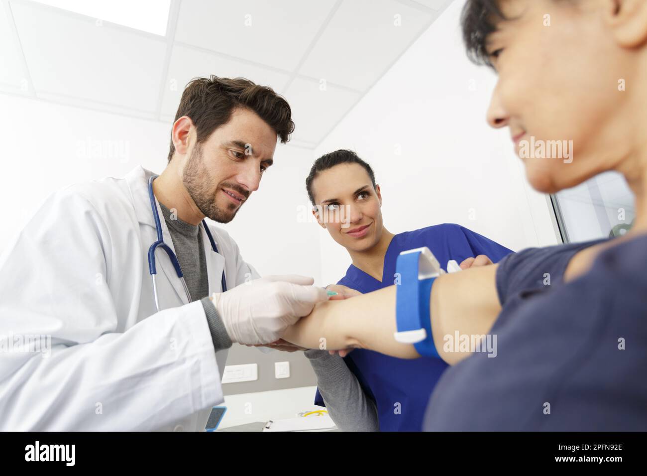 doctor taking pulse of the patient Stock Photo - Alamy