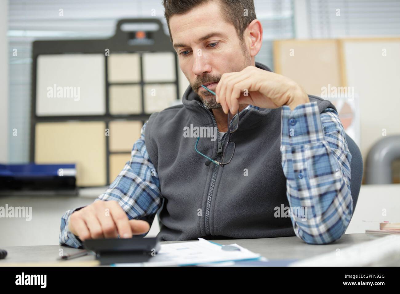engineer man working with drawings and calculator Stock Photo - Alamy