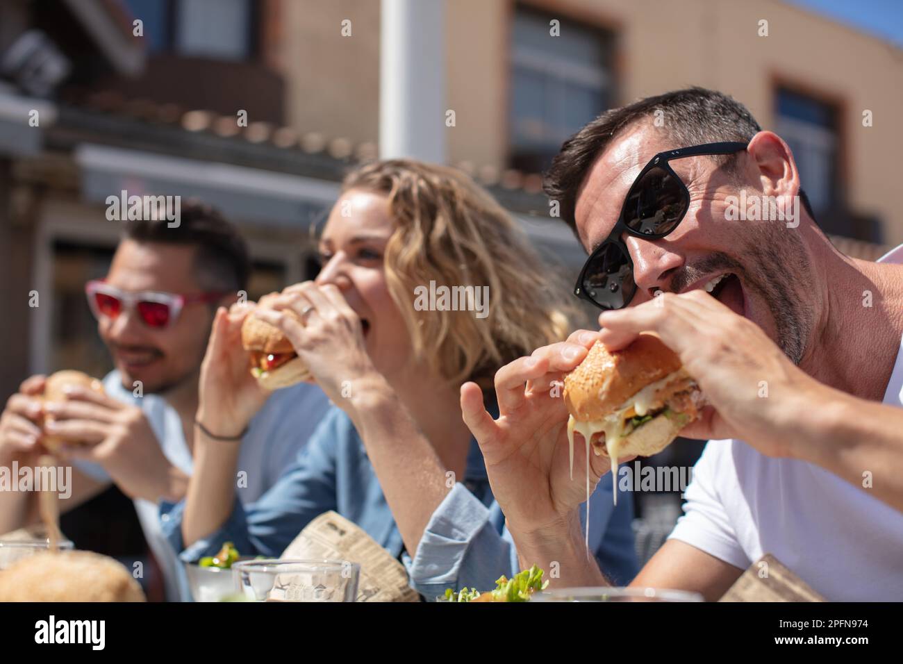Teen biting into burger hi-res stock photography and images - Alamy