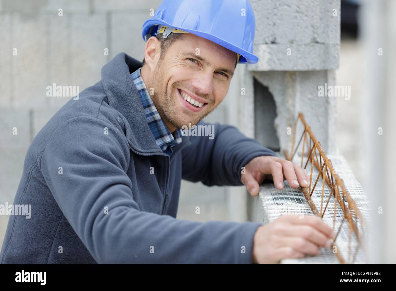 happy builder working with metal support Stock Photo - Alamy