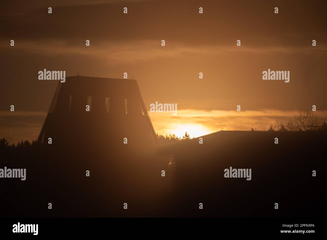 Trier, Germany. 18th Mar, 2023. The sun rises behind the top of the 38 ...