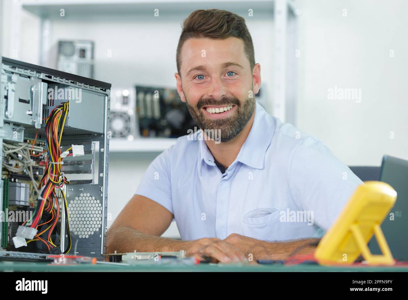 happy professional man repairing and assembling a computer Stock Photo ...