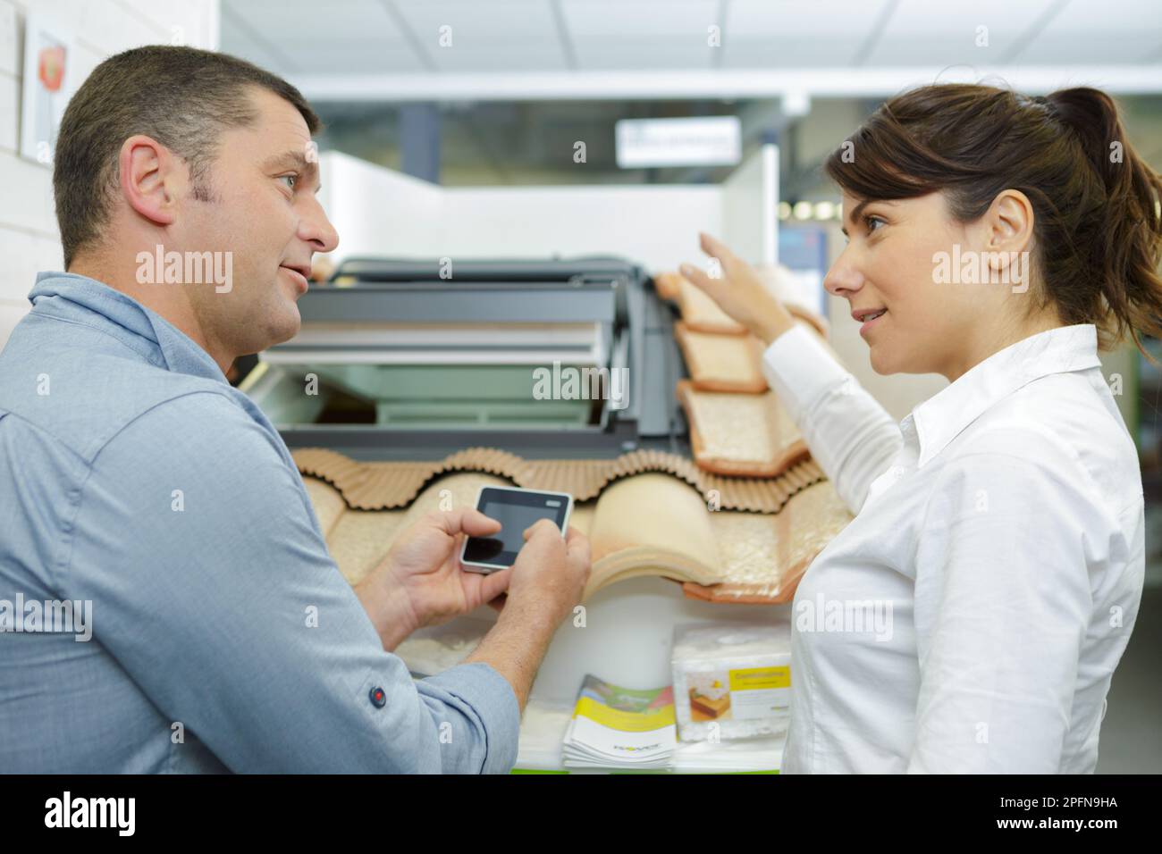 customer looking at roof light display in builders merchant store Stock ...