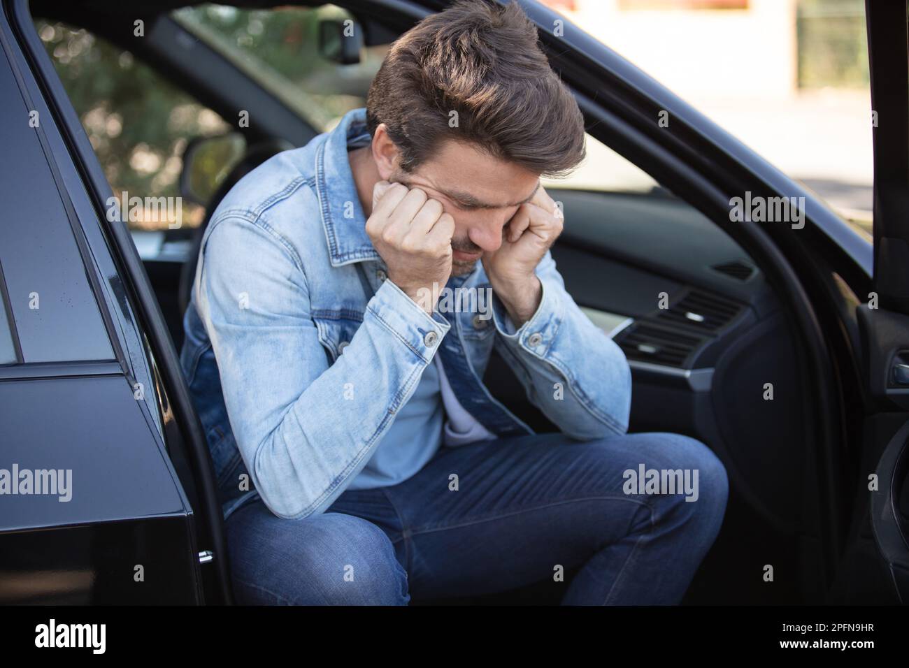 stressed man sitting on drivers seat of parked car Stock Photo - Alamy