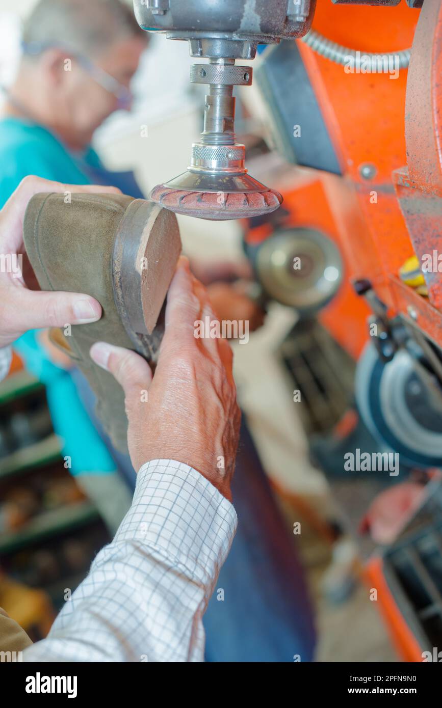 a shoemaker adjusting a heel Stock Photo - Alamy