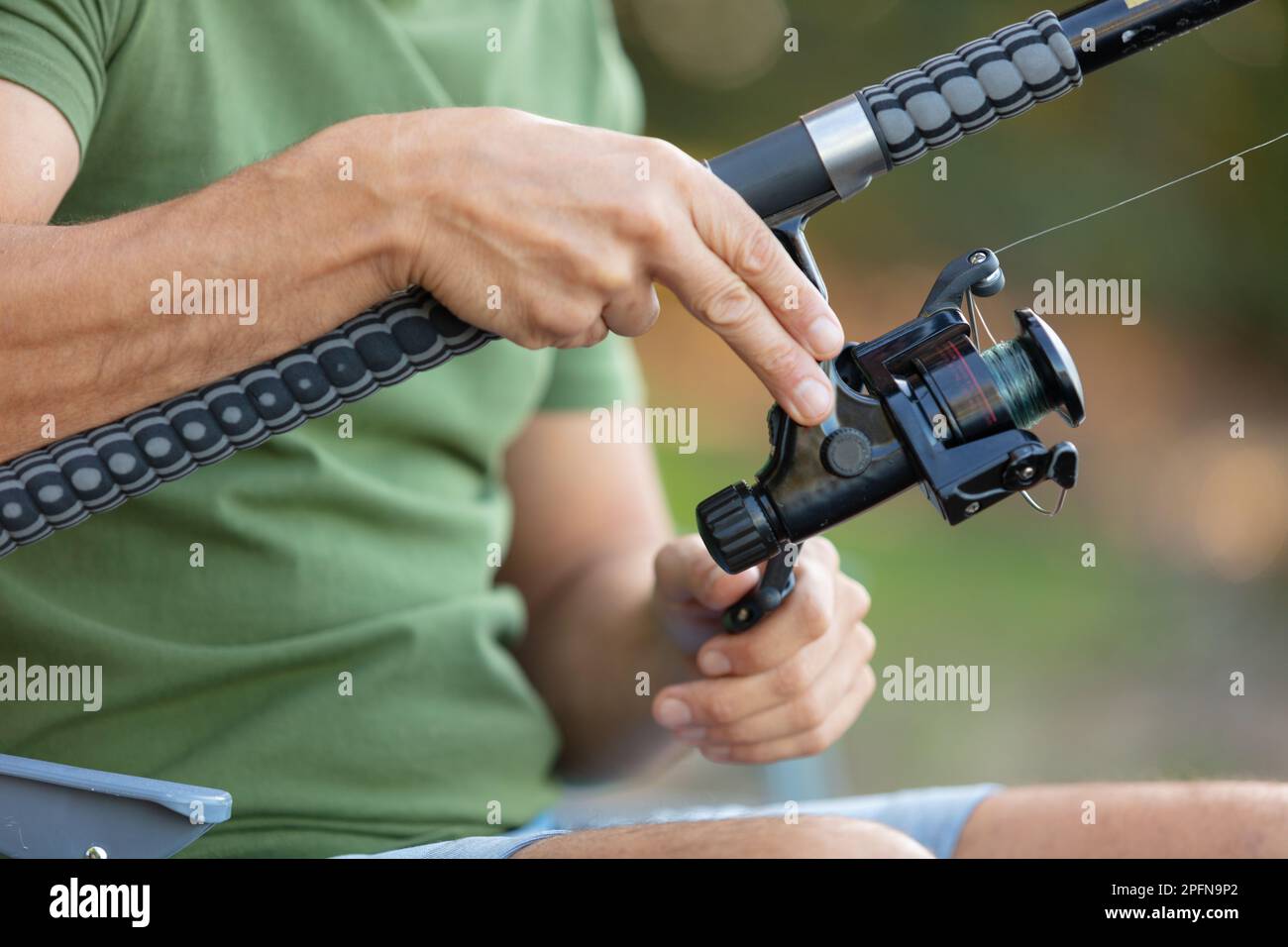 Hand on fishing pole hi-res stock photography and images - Alamy