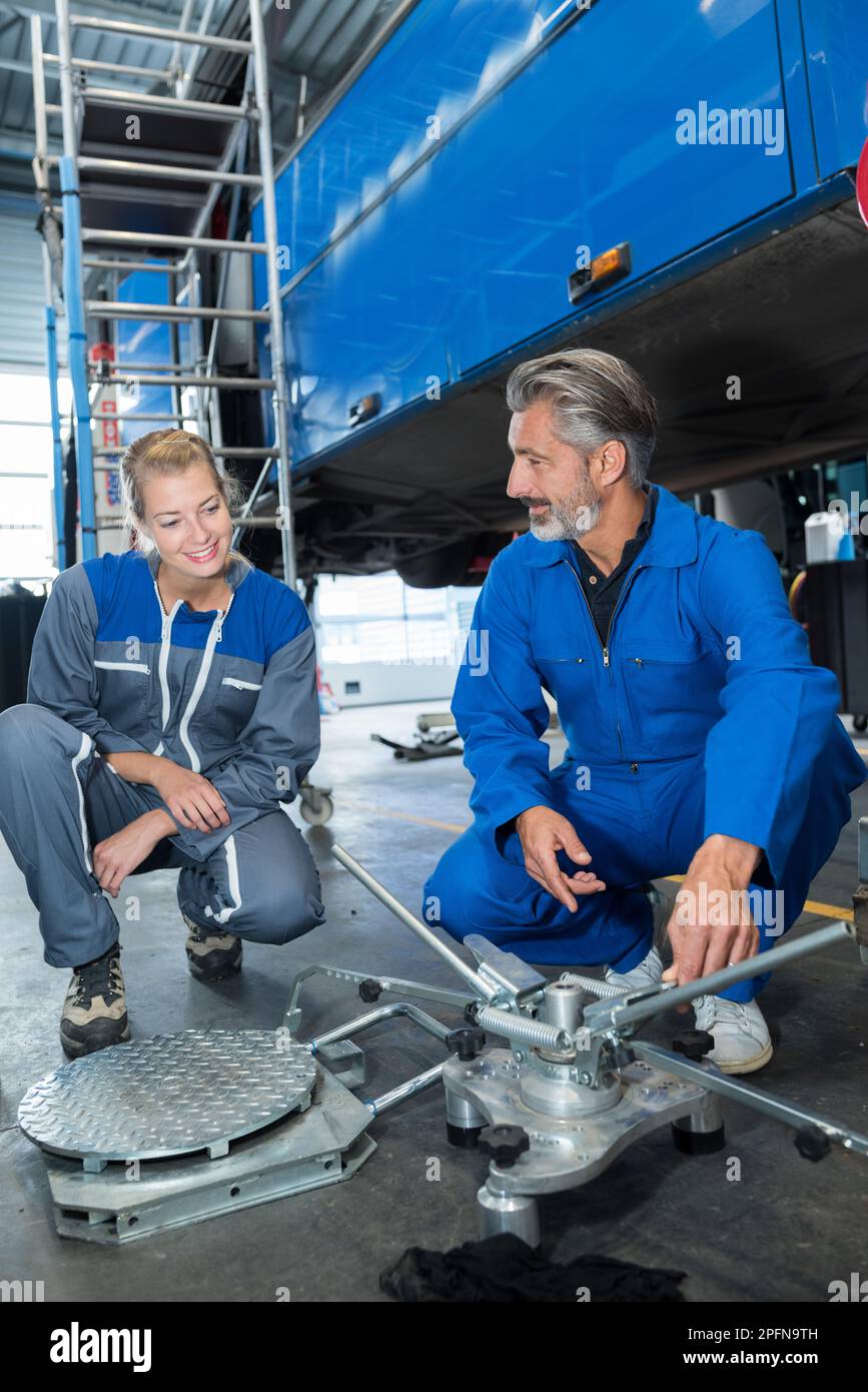 airplane service crew repairing plane in hangar Stock Photo - Alamy