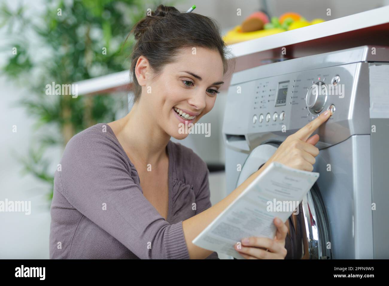 woman using new washing machine Stock Photo - Alamy