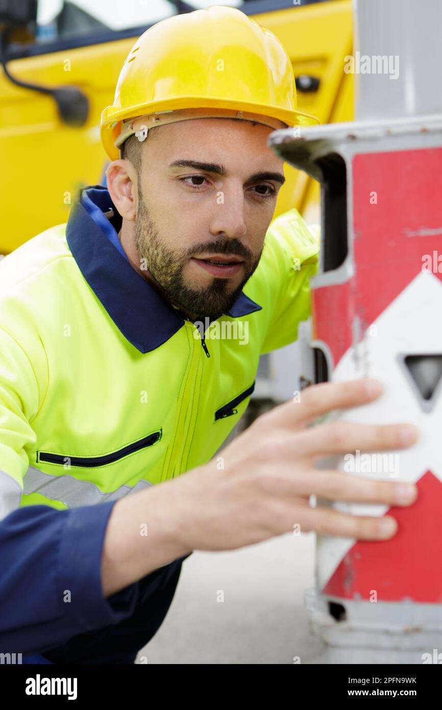 construction engineer and excavator in the background Stock Photo - Alamy