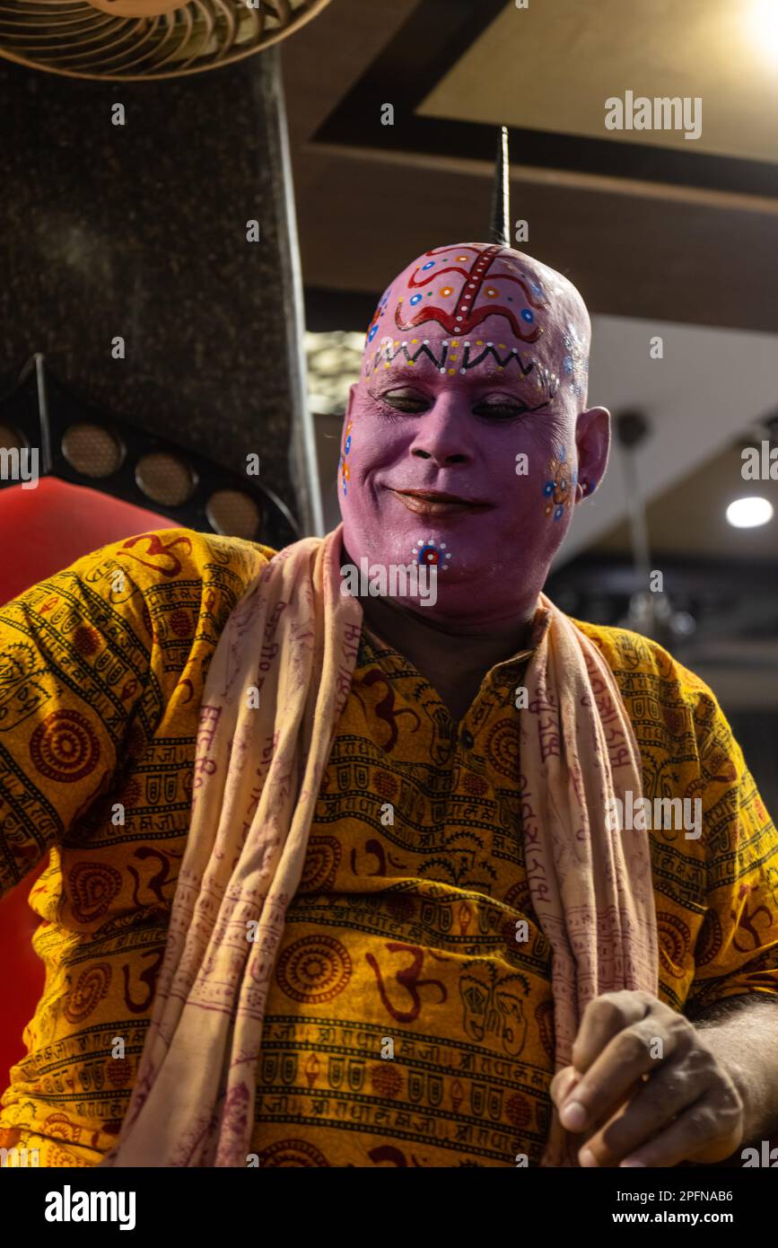Portrait of an male with painted face sitting at famous shop called as ...