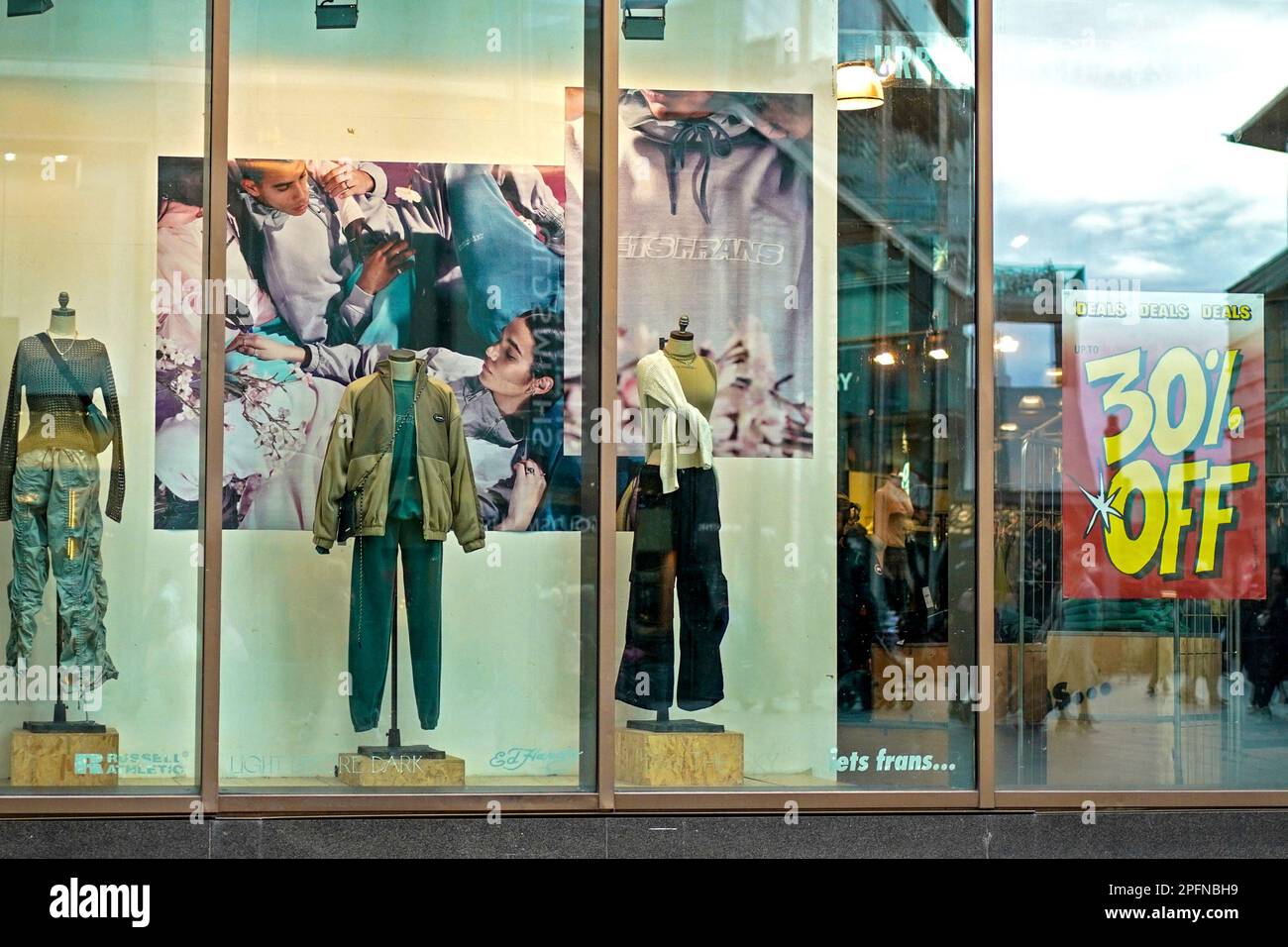 Sale signs in a shop window in Liverpool Stock Photo - Alamy