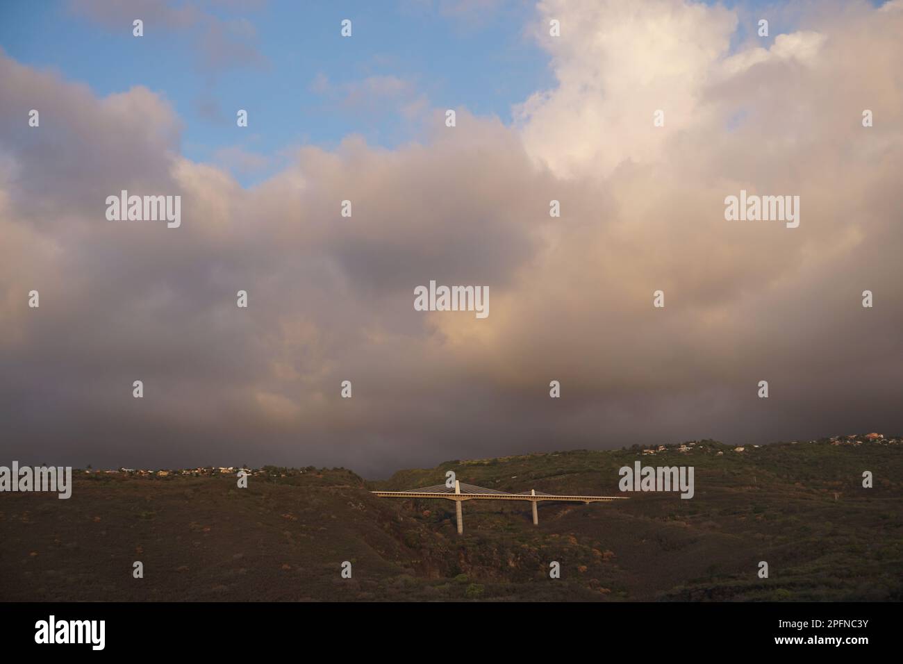 landscape scene of the sun setting on the bridge on the tropical island ...