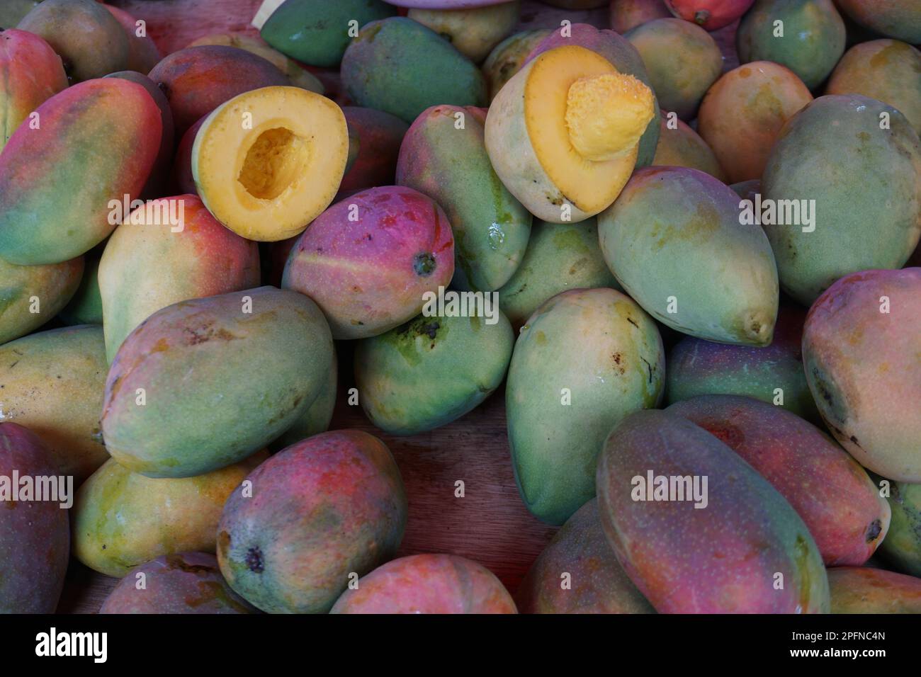 colorful mangoes on display at the outdoor market on the tropical ...