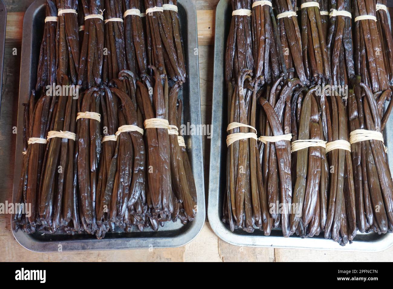 closeup on bundles of vanilla beans on display at the outdoor market on ...