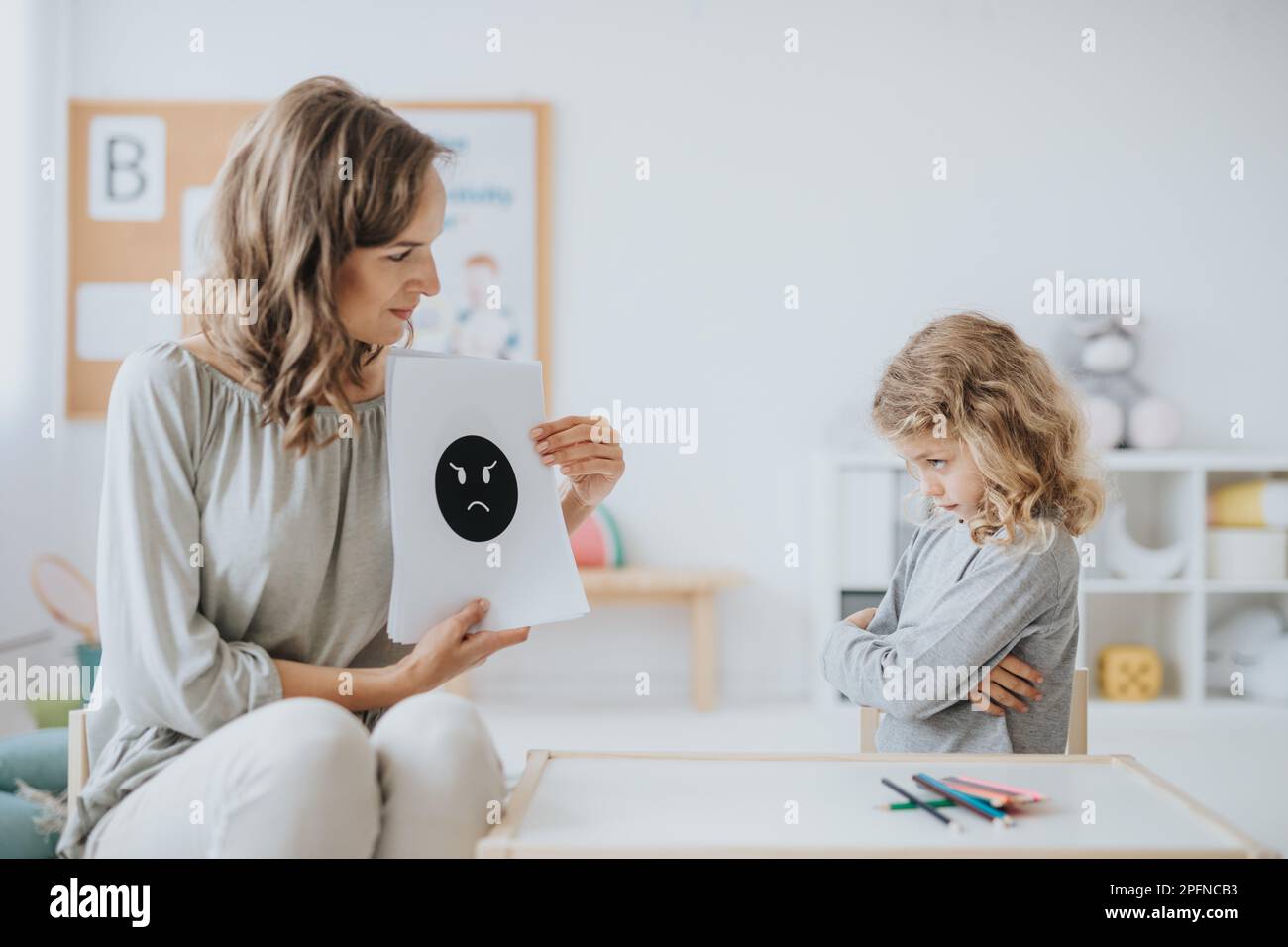 Young school therapist working with sad kid and his emotions Stock ...
