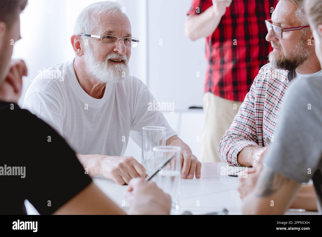 Grey senior therapist with problematic patient during counseling Stock ...