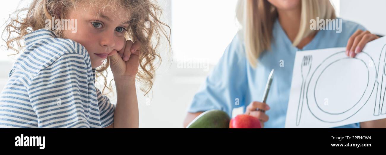 Friendly dietitian explaining the basics of healthy nutrition to a ...