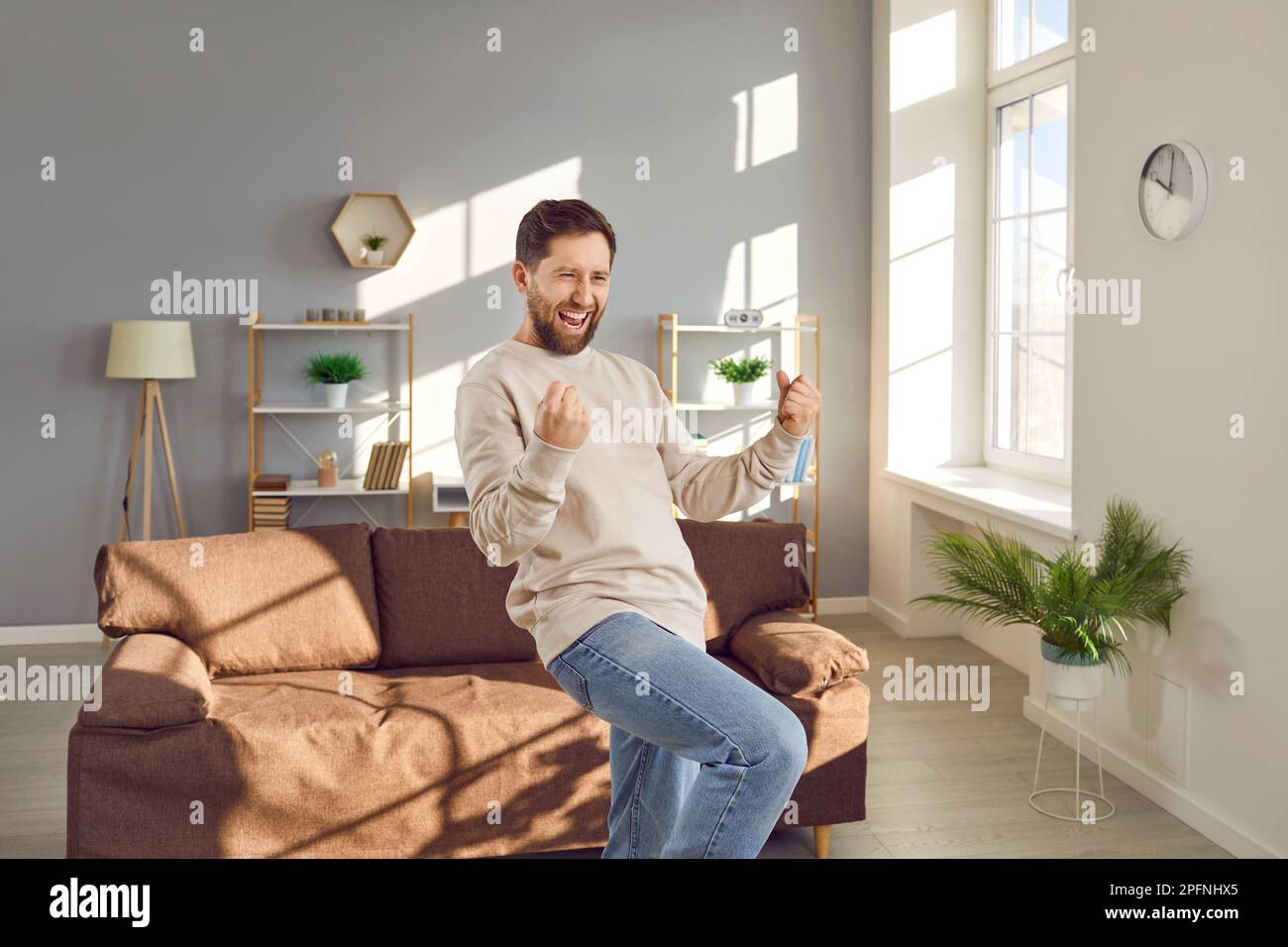 Happy, excited young man saying Yeah and doing a yes fist gesture with ...