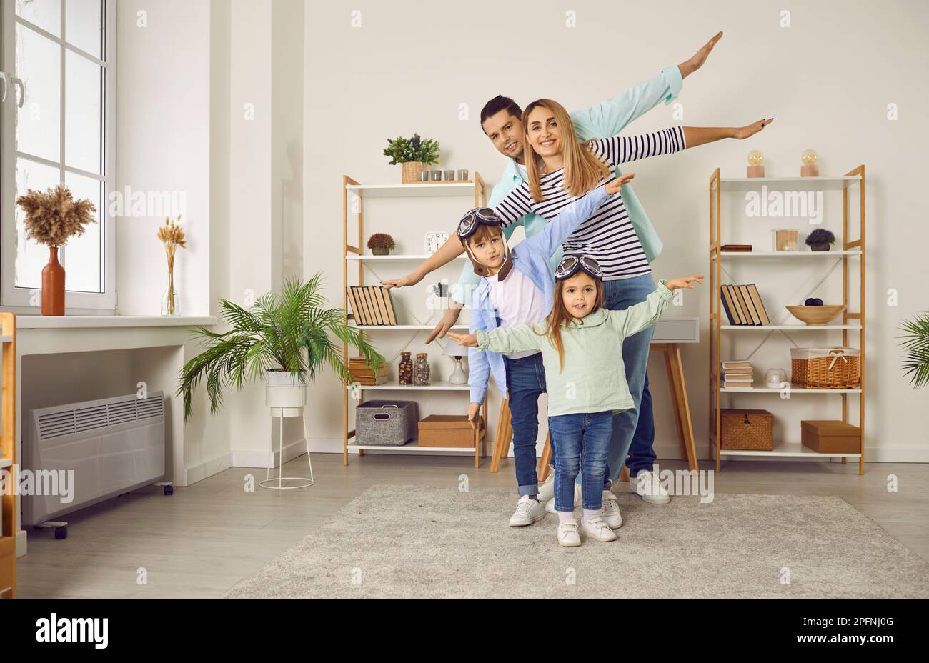 Happy family having fun with their kids in the living room at home ...