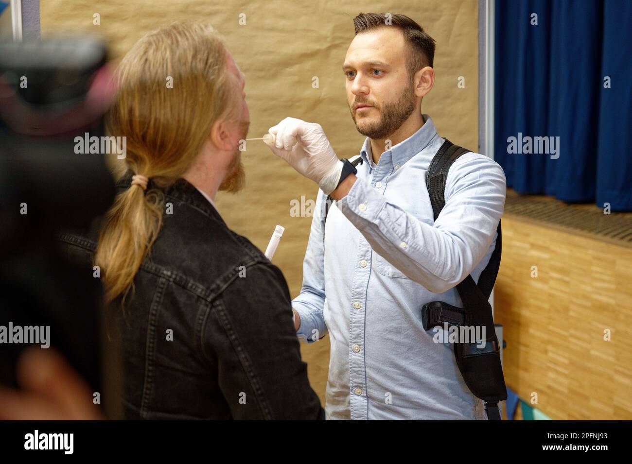 Cologne, Germany. 18th Mar, 2023. A police officer demonstrates how to ...