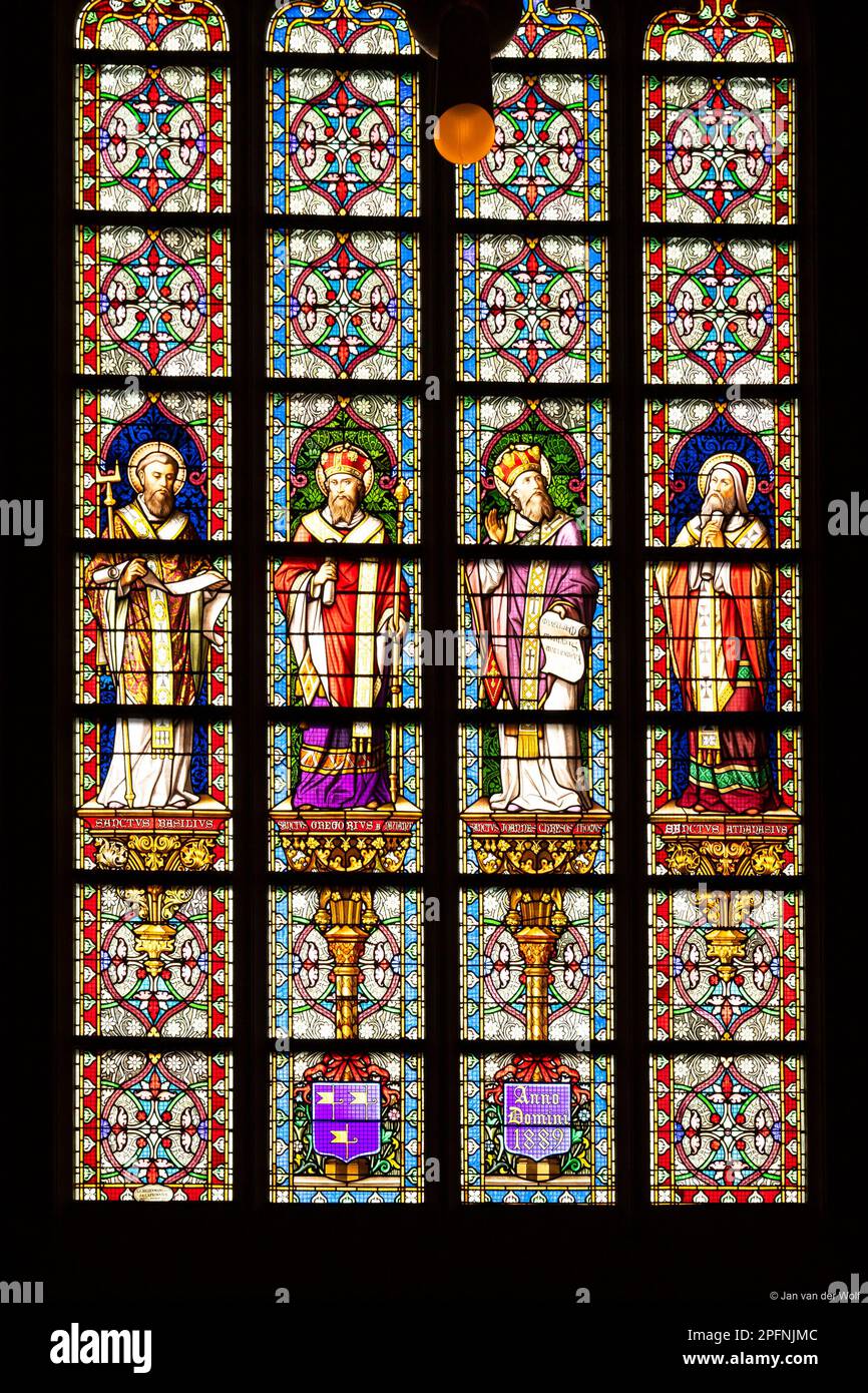 Stained glass window depicting a saint performing the sacrament of Holy ...