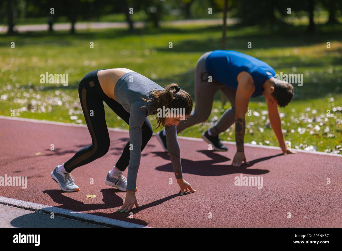 Two young friends getting into the starting positions for thier run at ...