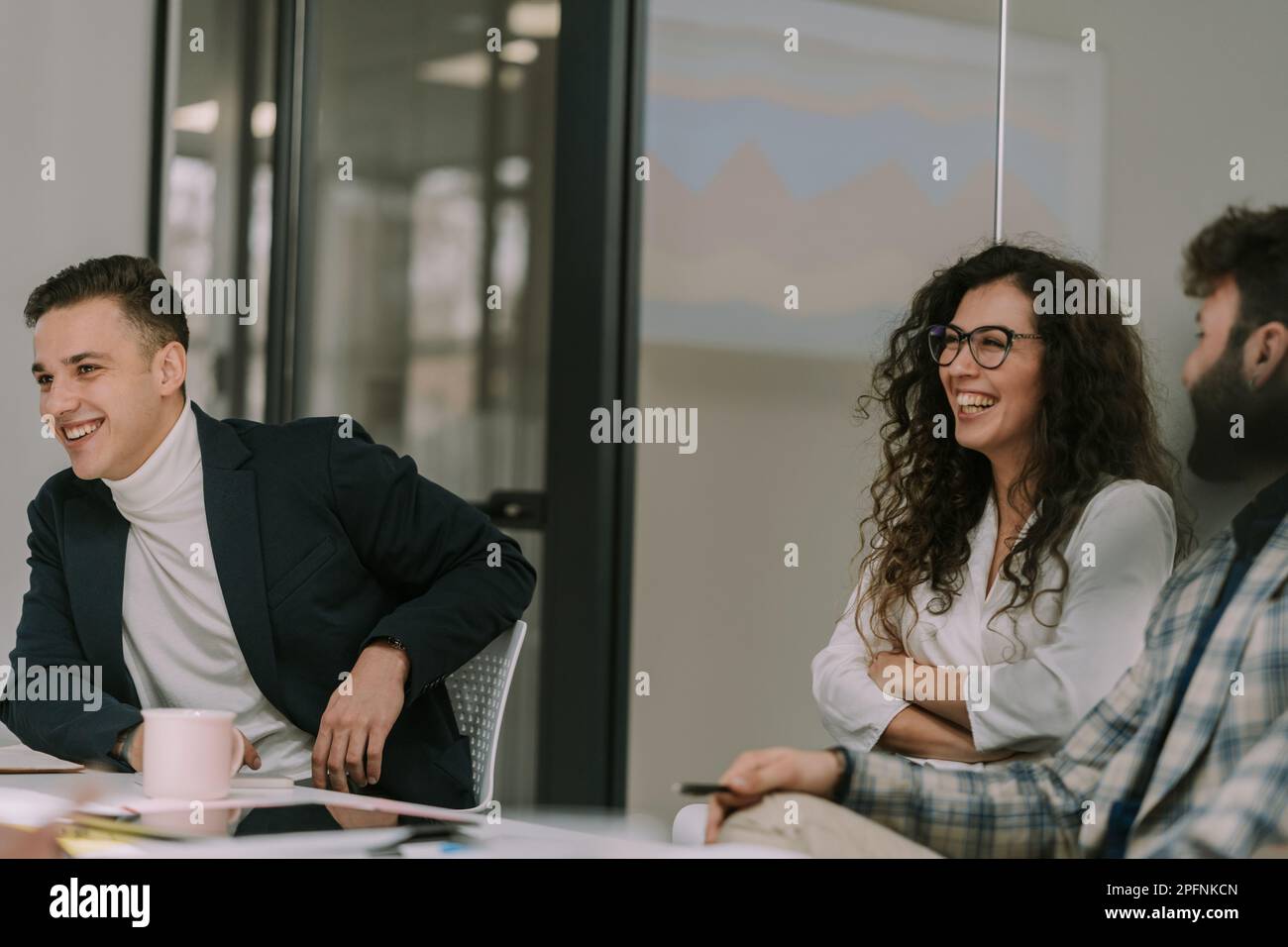 Beautiful young people having fun conversation at the meeting room ...
