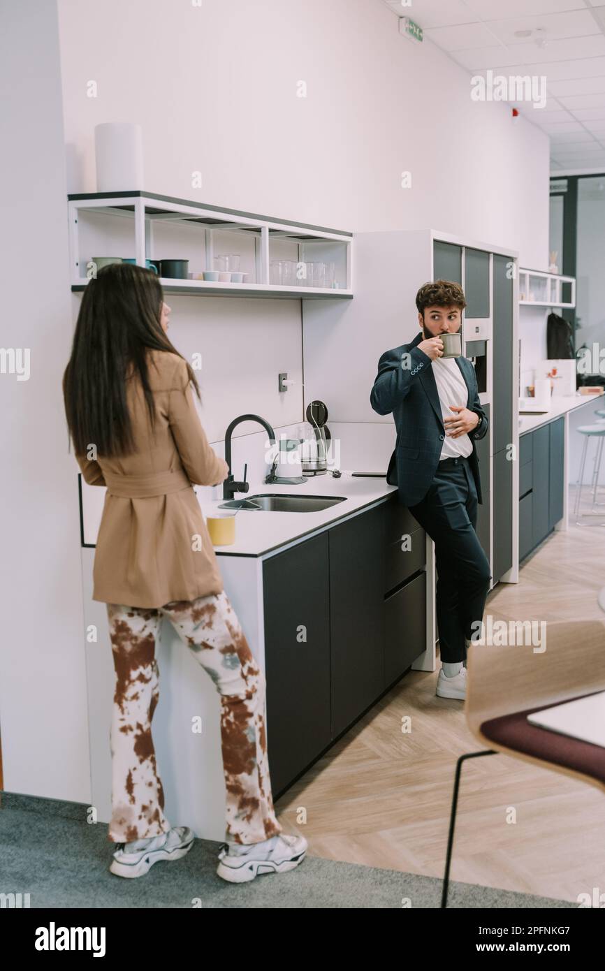 Business people at the office kitchen having a tea time and ...