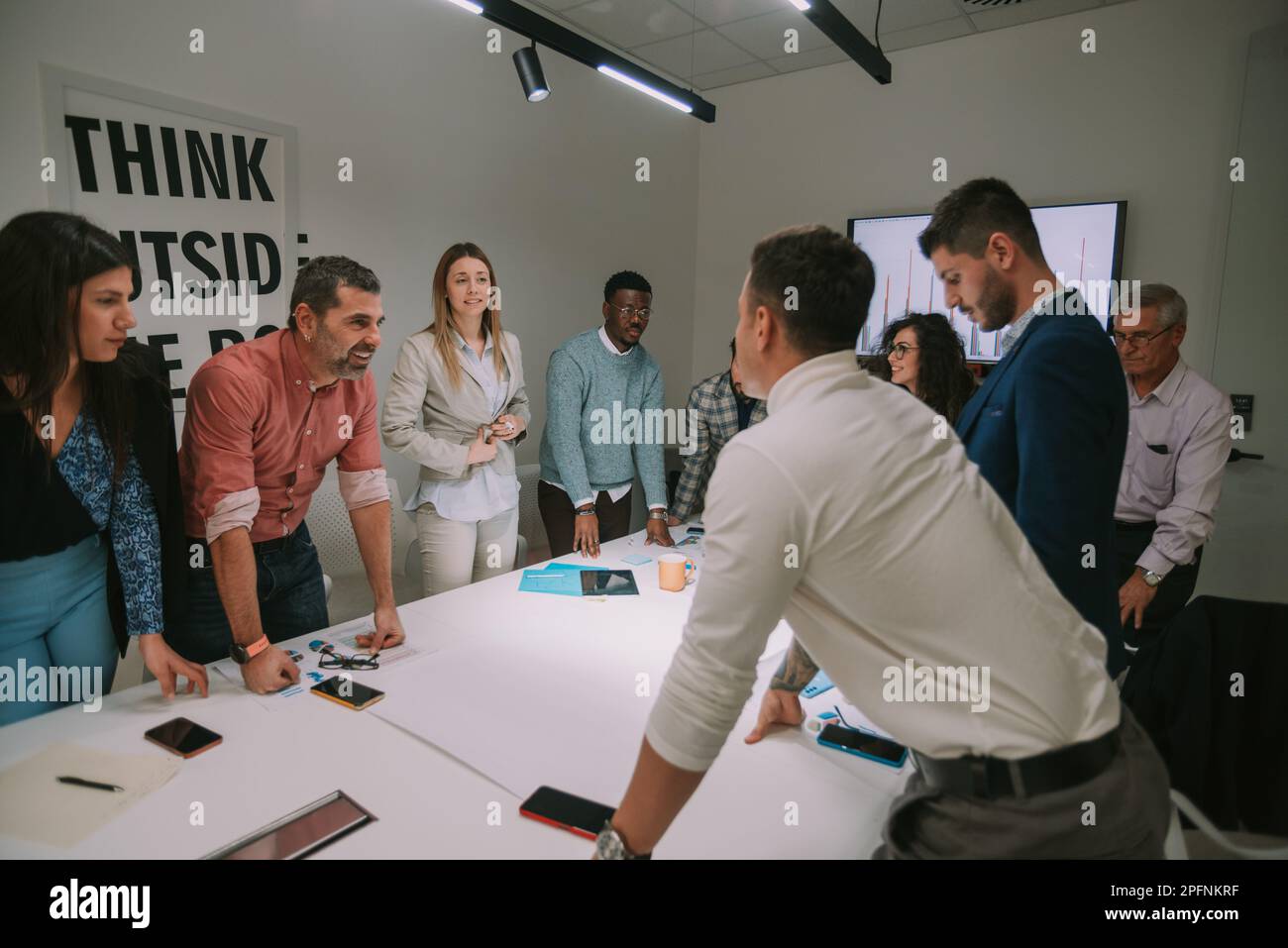 Business group standing above the business table while they having a ...