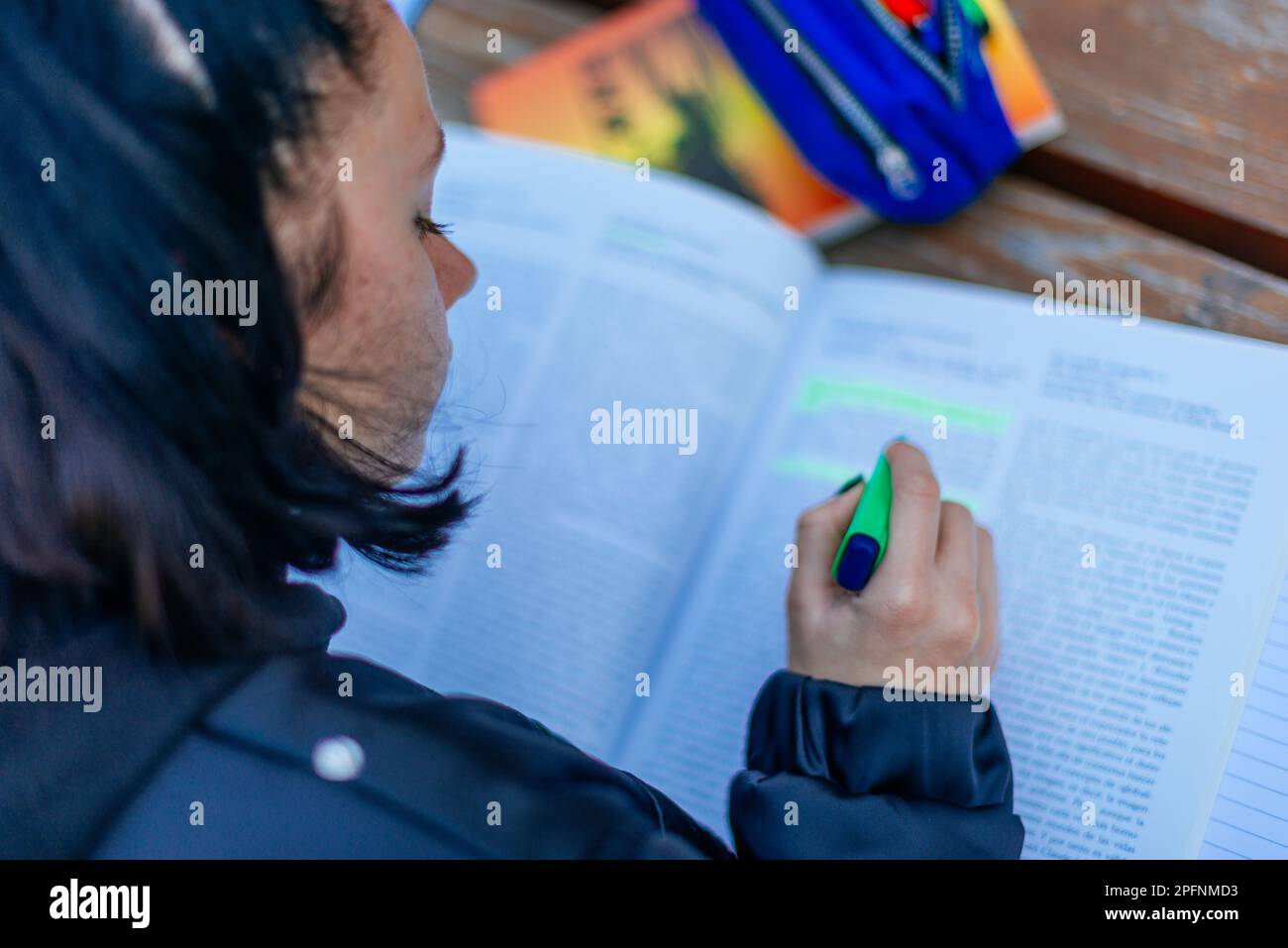 Two beautiful learners are underlining the most important parts before ...