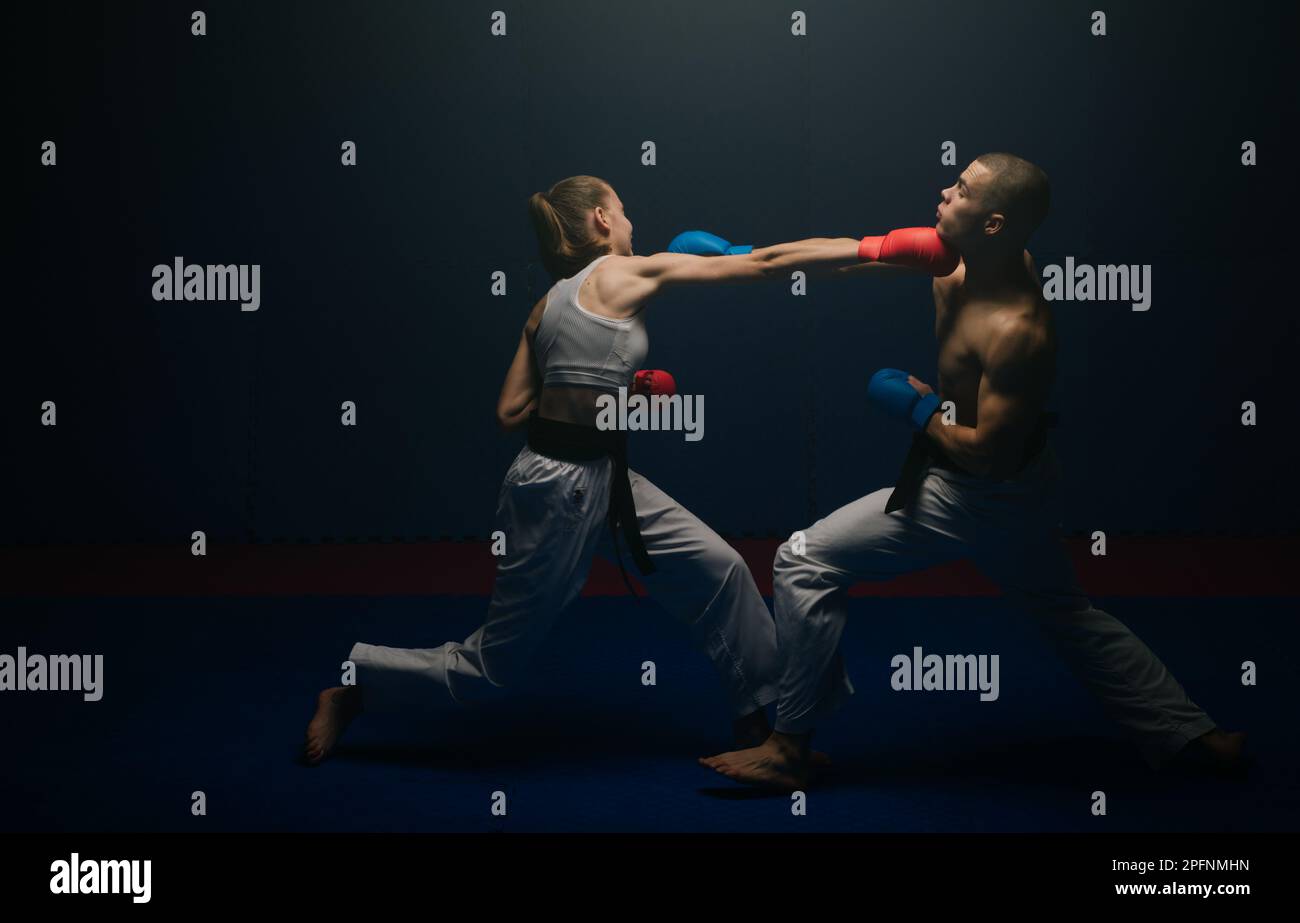 Young karate friends doing some karate pose while standing at the ...