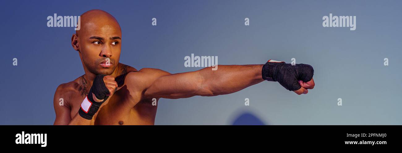 Professional kickboxer is training and practicing punch on studio ...