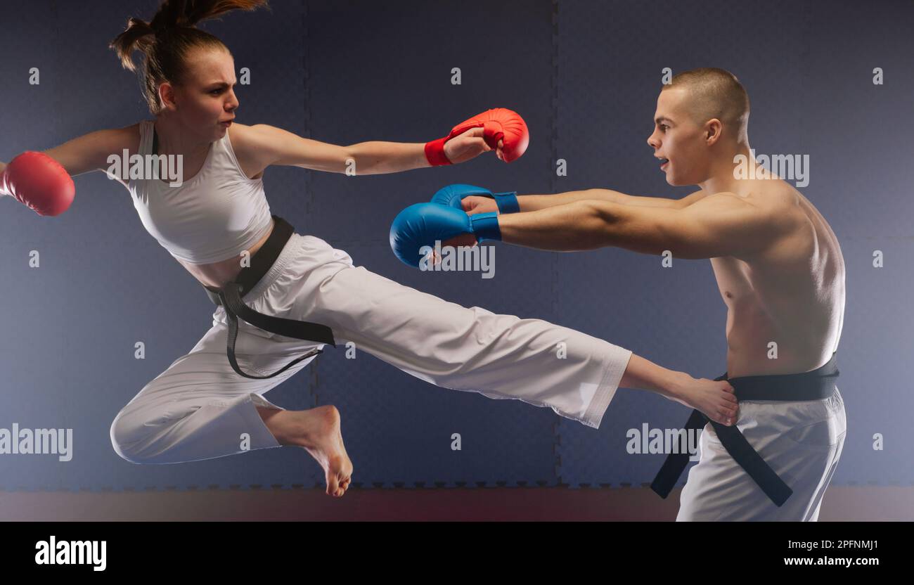 Beautiful and strong karate girl doing the foot kick on her karate ...